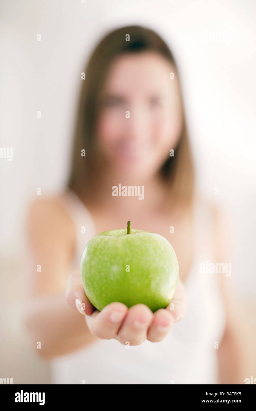 Apple held in a woman's hand Stock Photo - Alamy