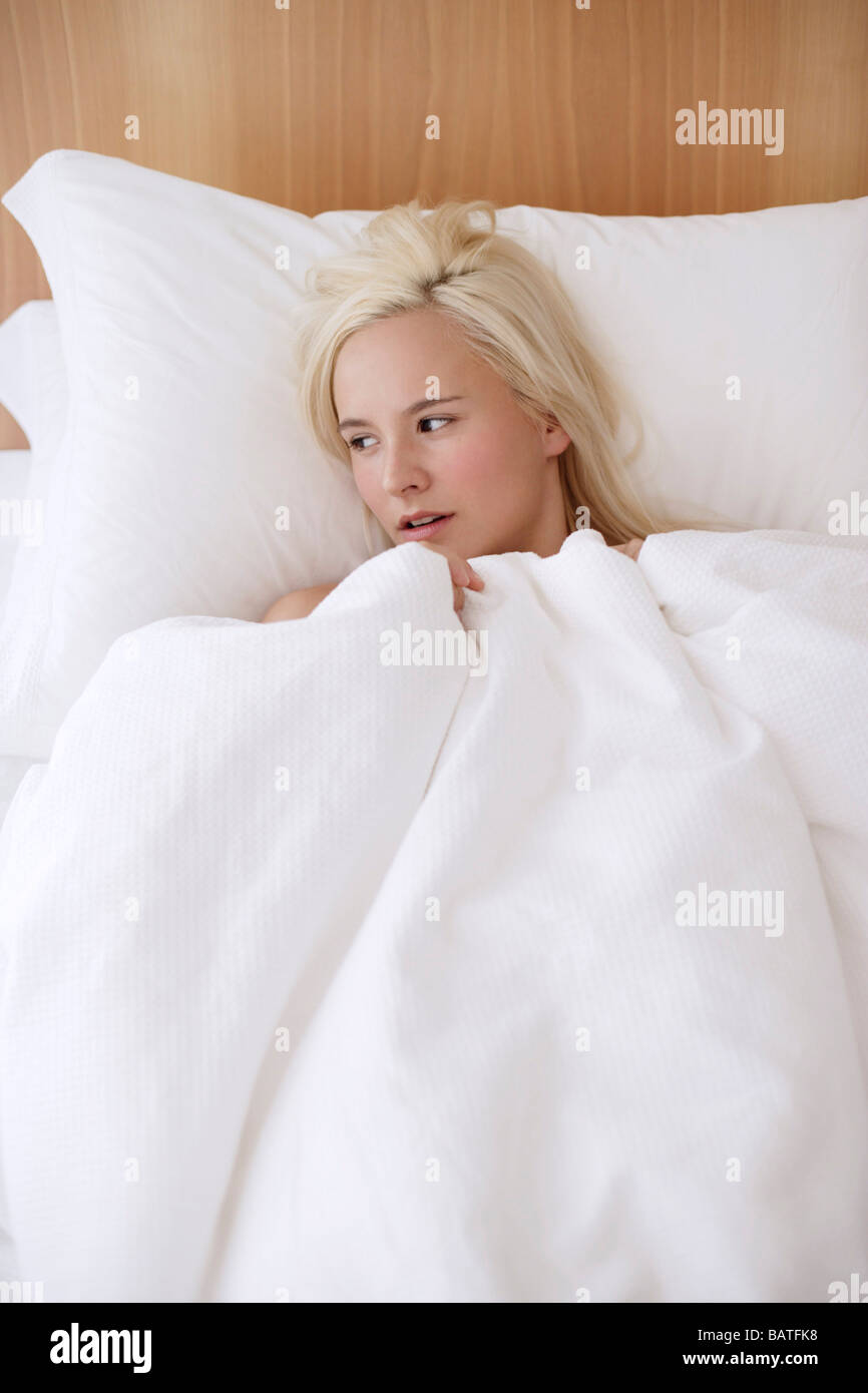 Woman in bed Stock Photo - Alamy