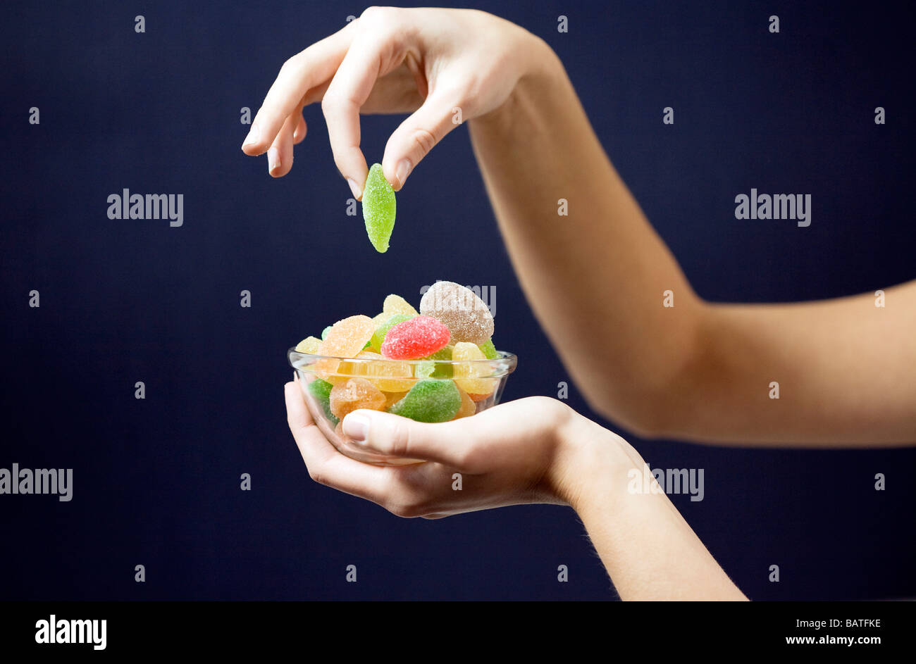 hands of young woman holding candies Stock Photo - Alamy