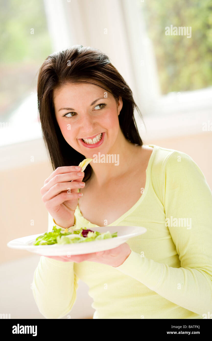 Girl eating salad Stock Photo - Alamy