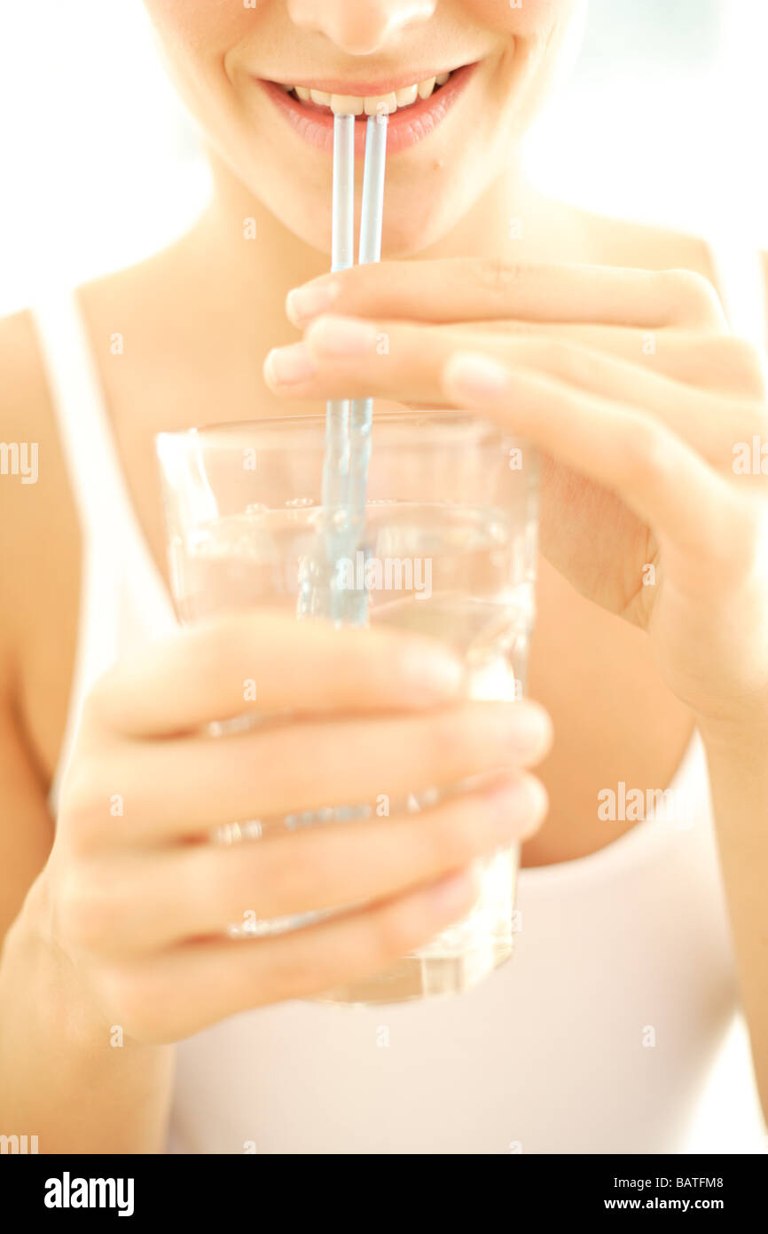 Woman drinking water through straw hi-res stock photography and images ...