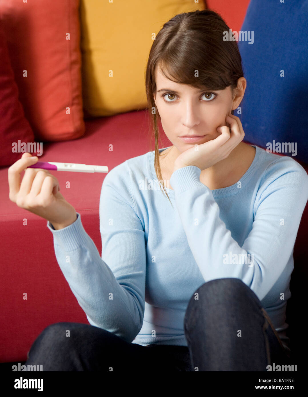 young woman holding her pregnancy test Stock Photo - Alamy