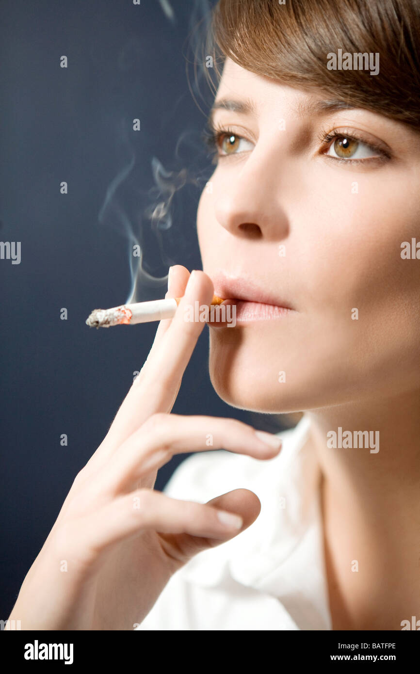 young woman smoking a cigarette Stock Photo - Alamy