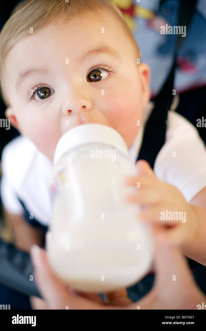 Baby drinking. Nine month old boy drinking a bottle of milk Stock Photo ...