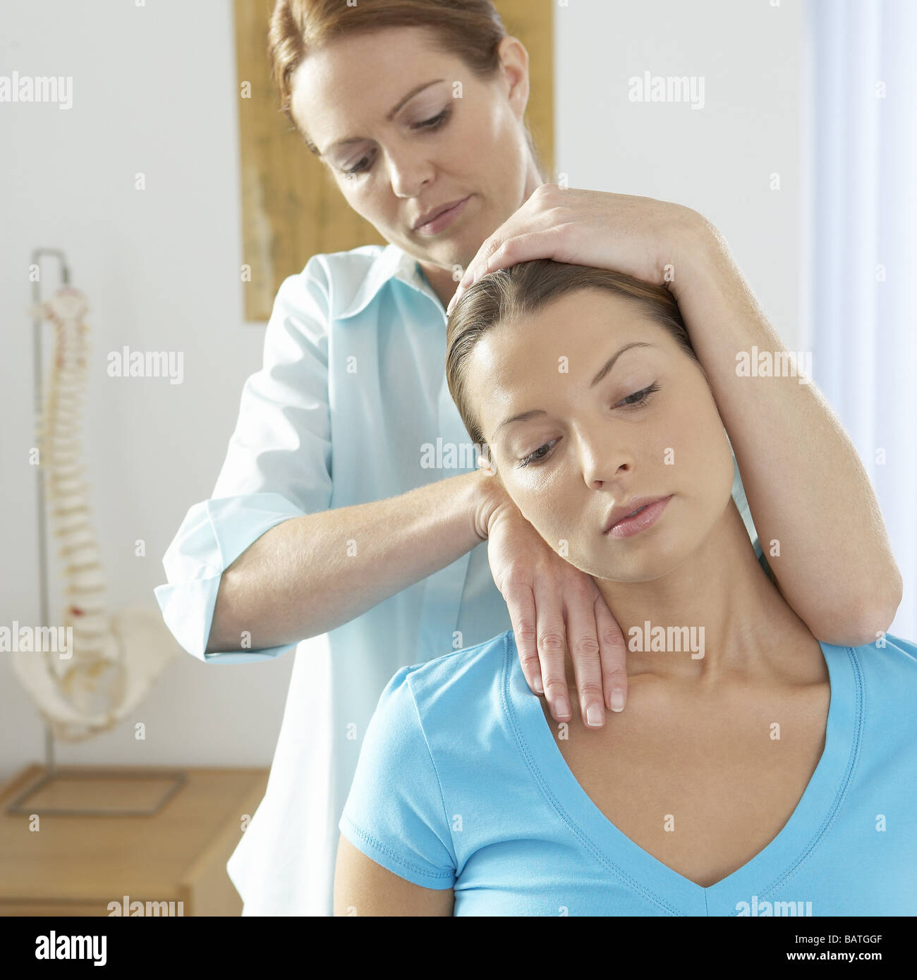 MODEL RELEASED.Chiropractor treating her patient usingTorticollis ...