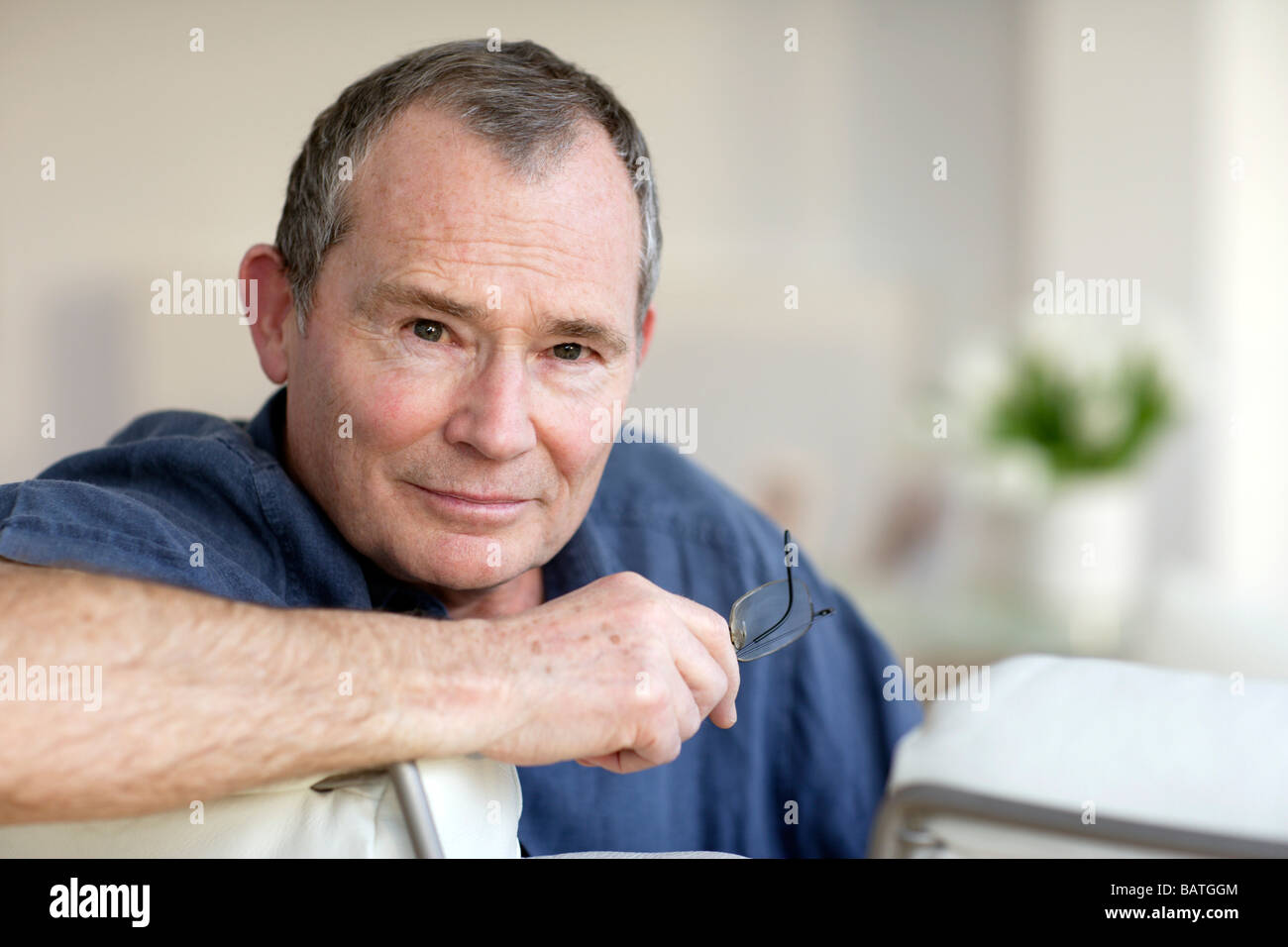 Man holding his glasses Stock Photo - Alamy
