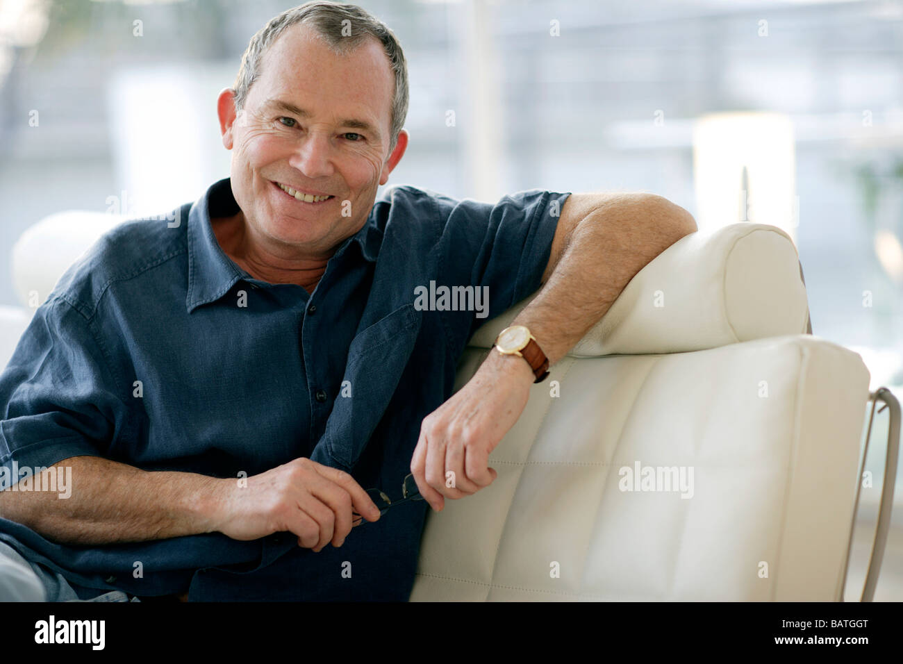 Man holding his glasses Stock Photo - Alamy