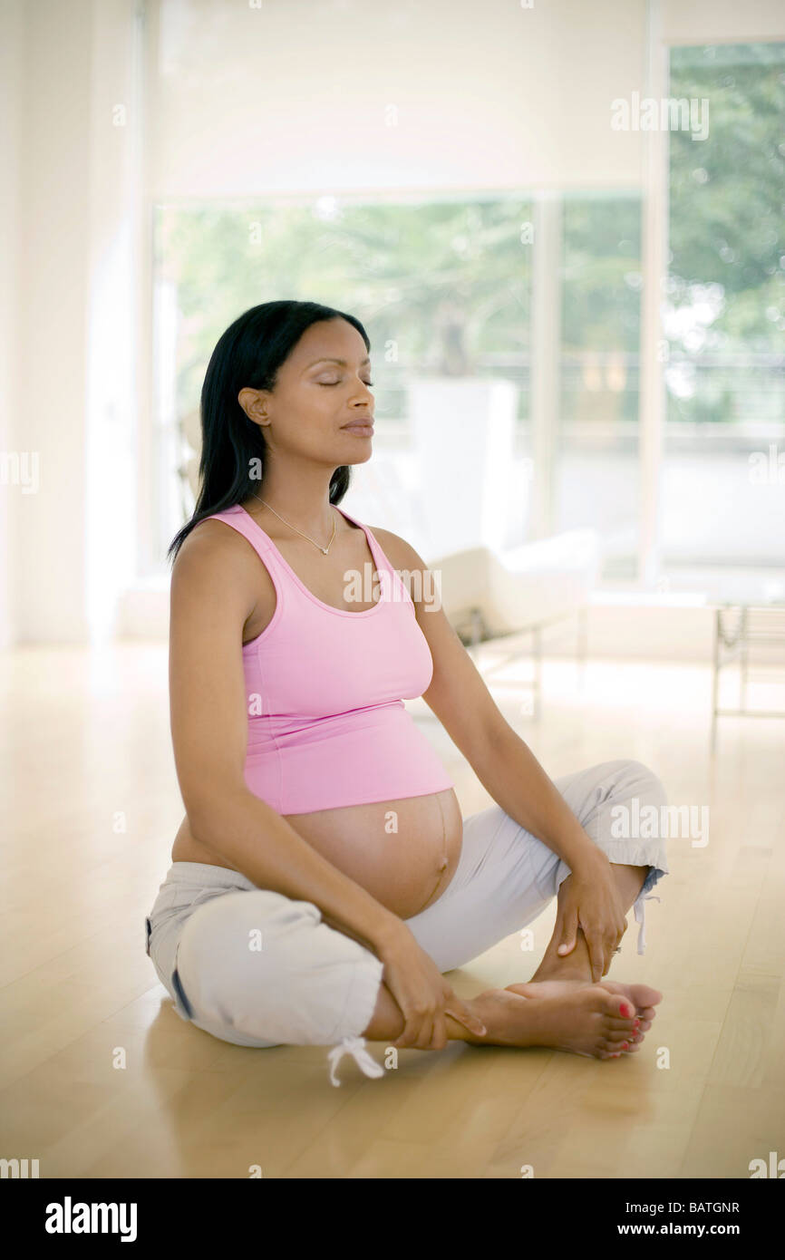 Yoga in pregnancy. Woman sitting in the Cobbler's position. She is at ...