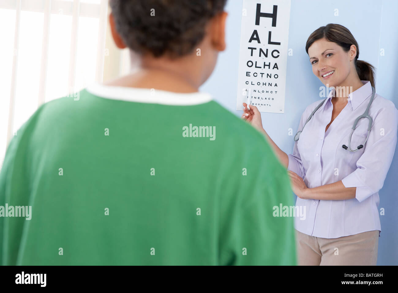 eye-examination-doctor-instructing-a-child-patient-to-read-the-letters