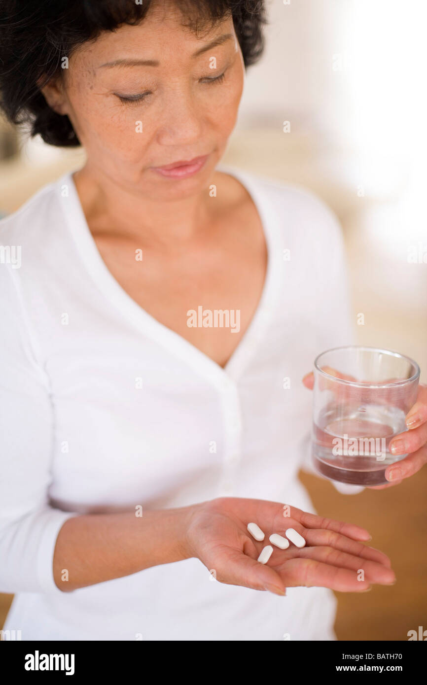 Woman taking pills middle aged hi-res stock photography and images - Alamy