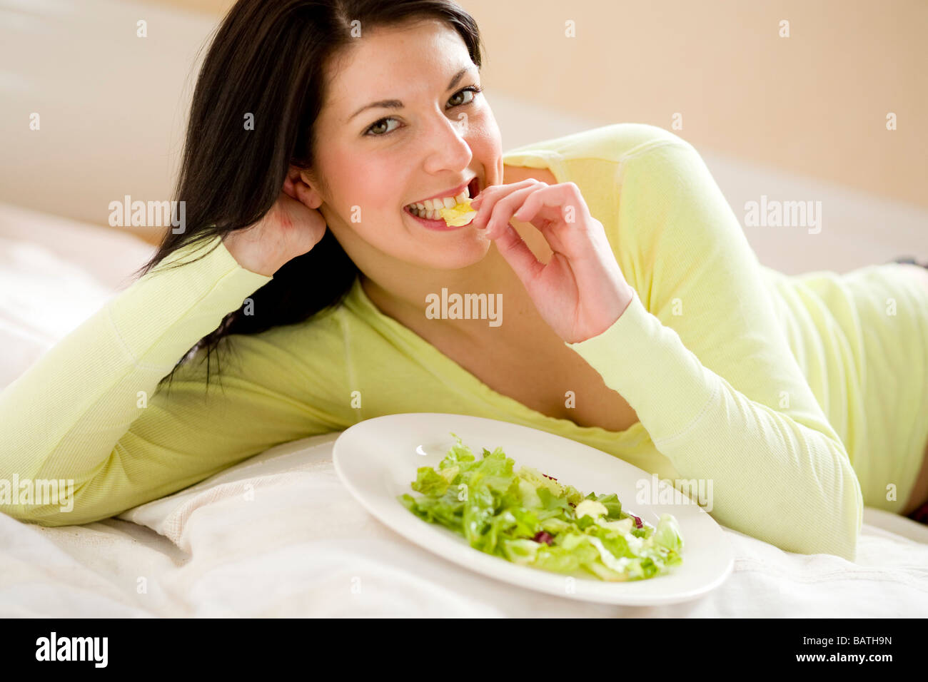 Girl eating salad Stock Photo - Alamy