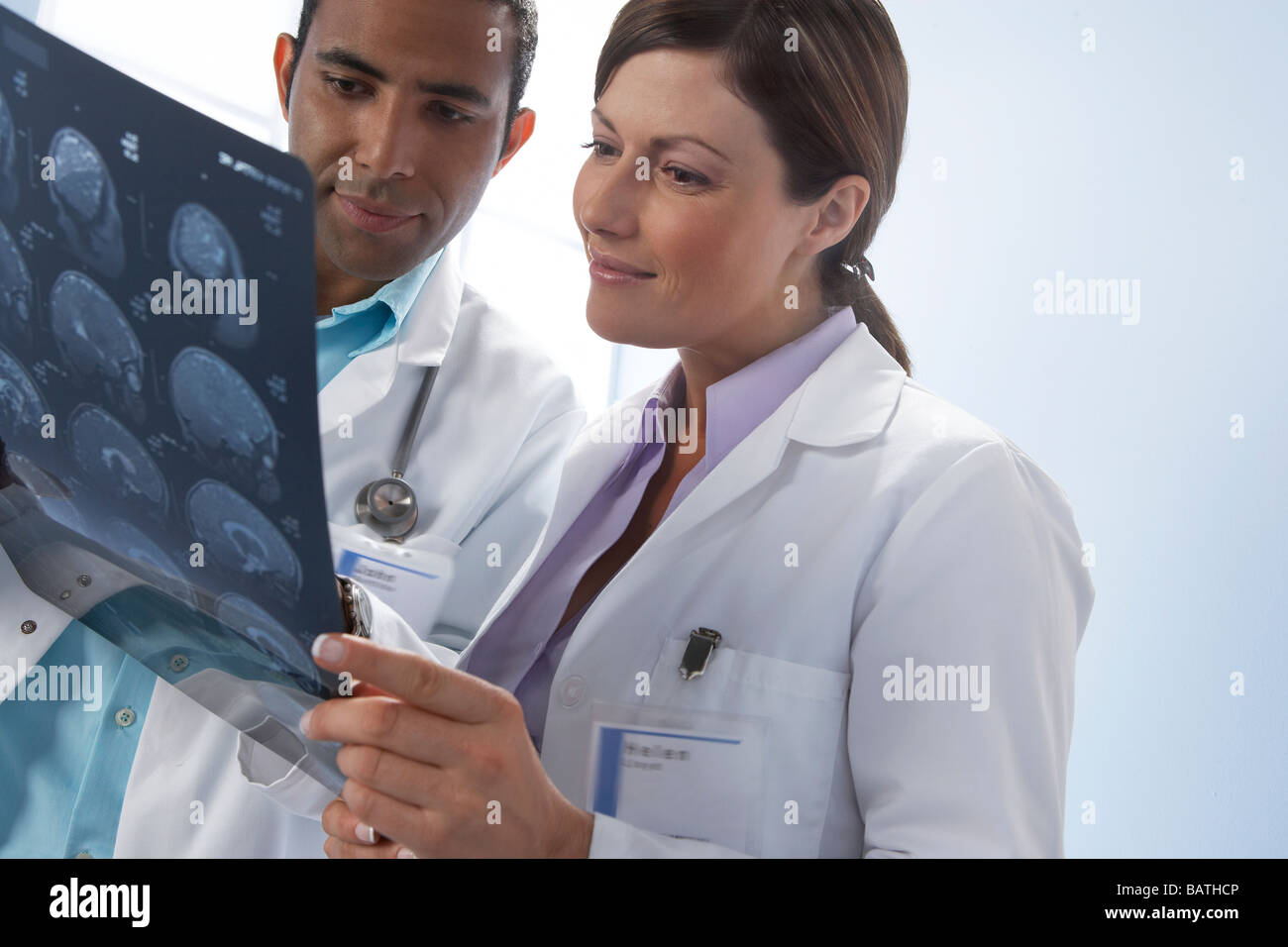 Doctors examining MRI scans.The scans are sagittal (side view) sections ...