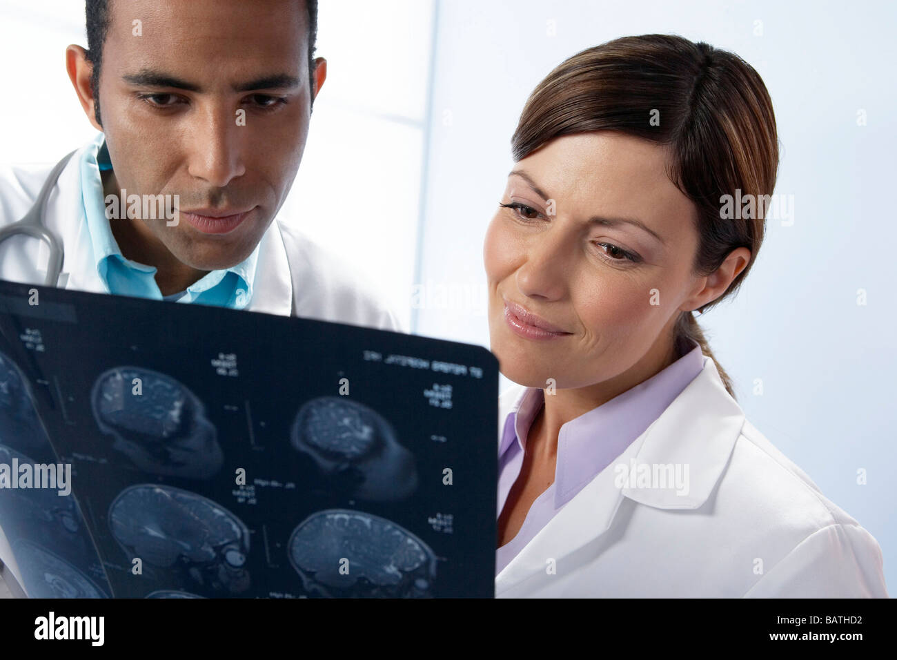 Doctors examining MRI scans.The scans are sagittal (side view) sections ...