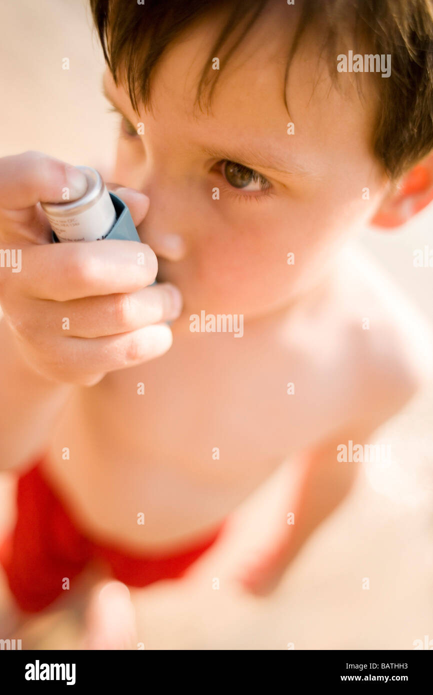 A child using an inhaler for the treatment of asthma hi-res stock ...