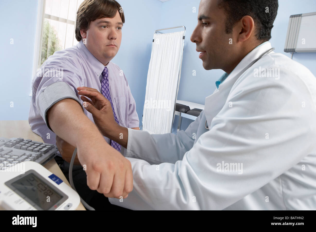 Measuring blood pressure.Doctor removing an inflatable cuff from the ...