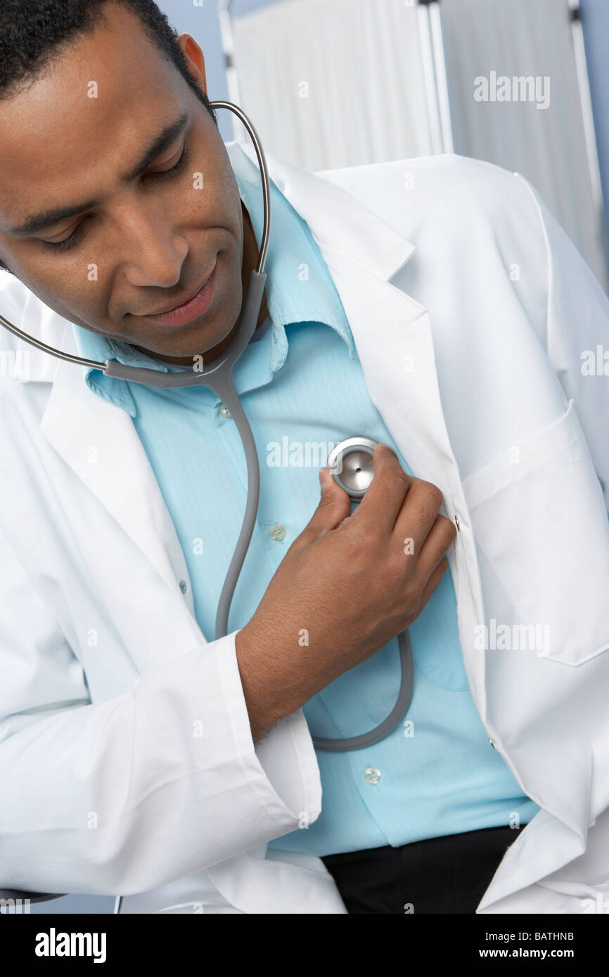 Doctor listening to his heartusing a stethoscope, a medical device that ...
