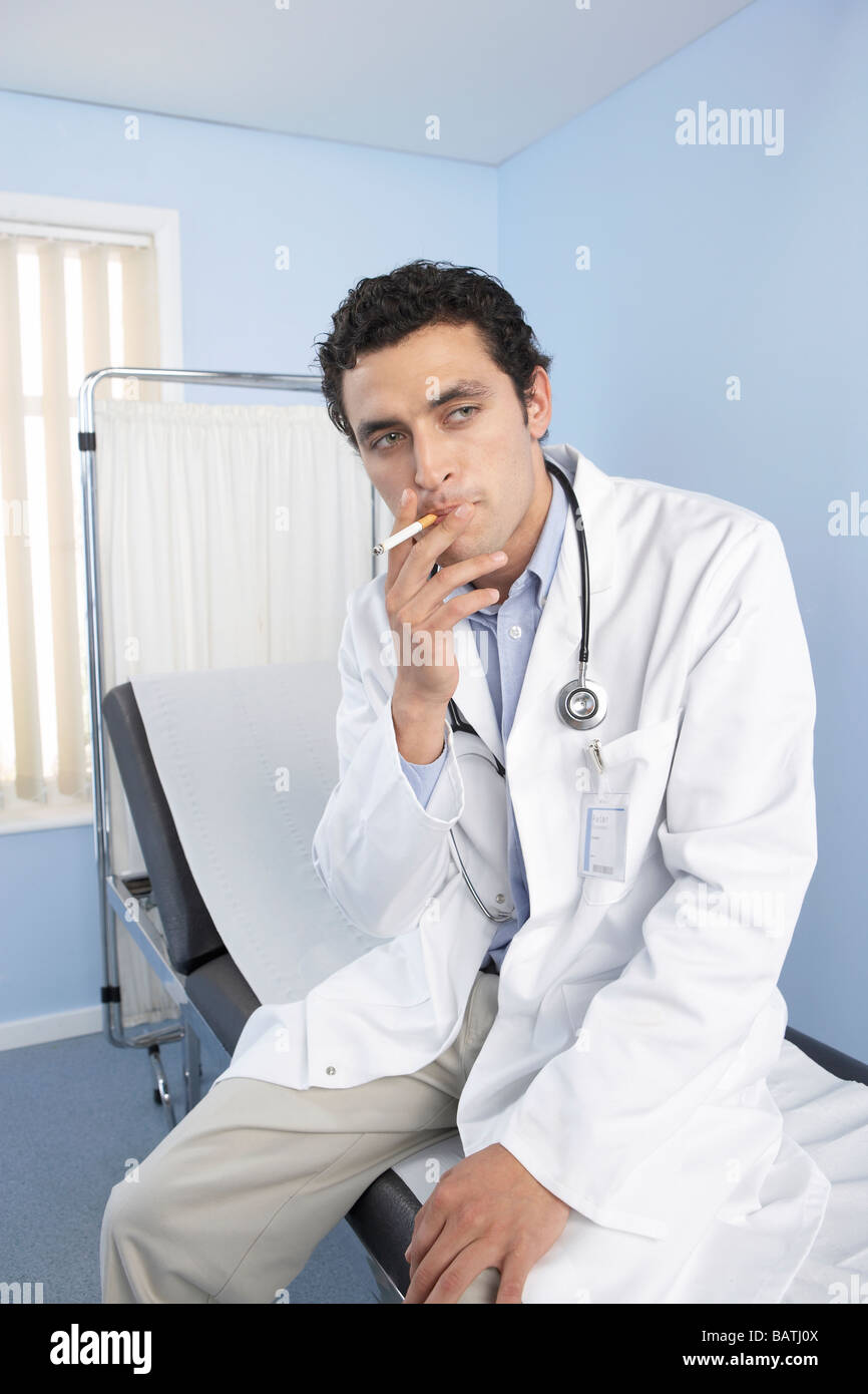 Doctor smoking a cigarette. Cigarettes contain the addictive drug ...