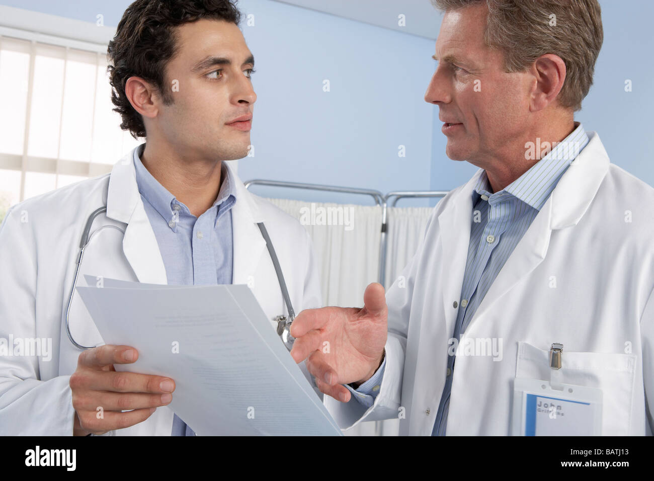 Doctors talking. Two doctors discussing a patient medical records Stock ...