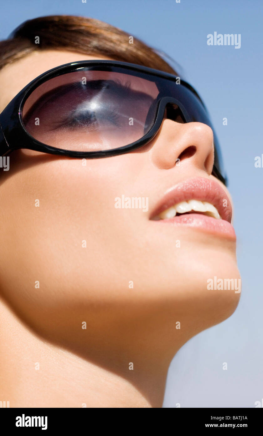 Woman wearing sunglasses. The lenses protect the eyes from the UV radiation in sunlight Stock ...