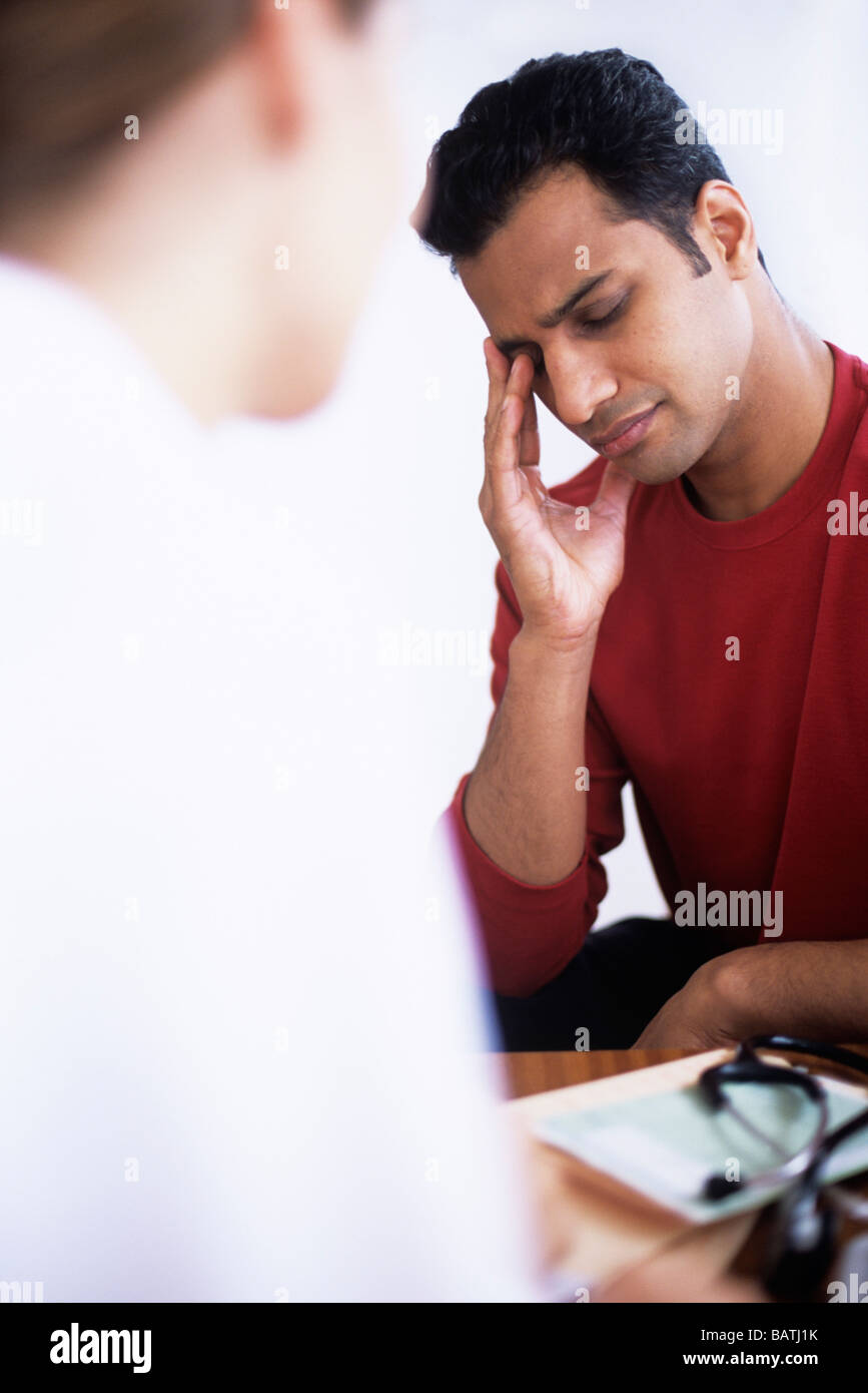 Medical consultation. Male patient consulting his general practioner ...