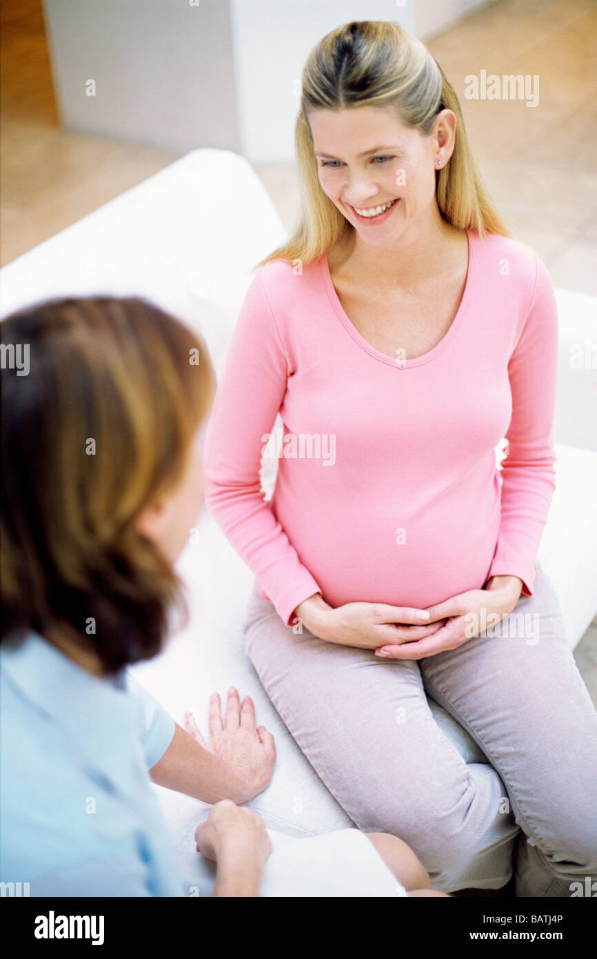 Obstetric examination. Midwife undertaking a consultation with a ...