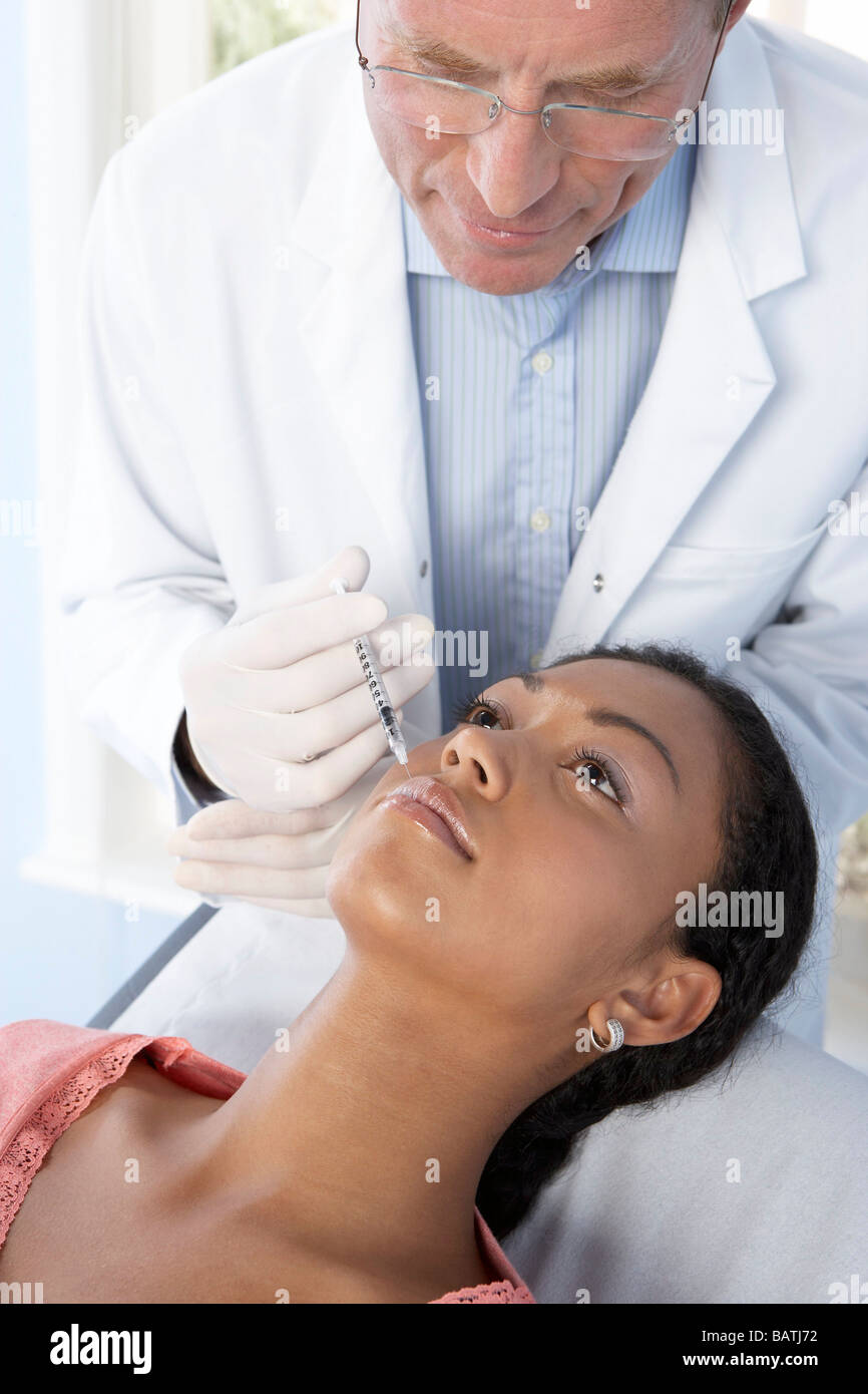 Botox treatment. Patient having botox injected into her face. Botox is ...