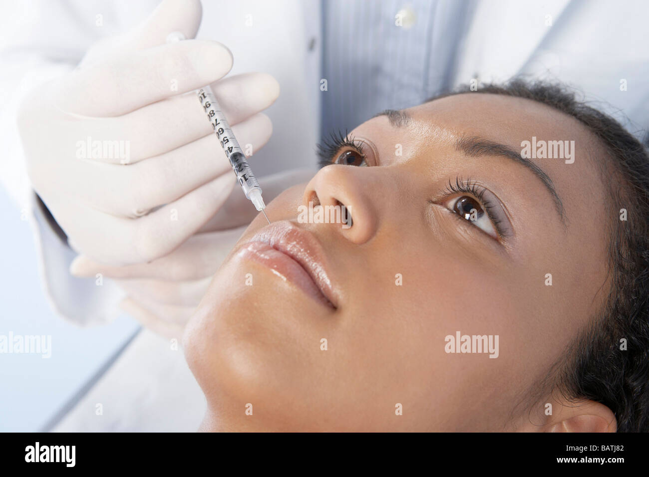 Botox treatment. Patient having botox injected into her face. Botox is ...