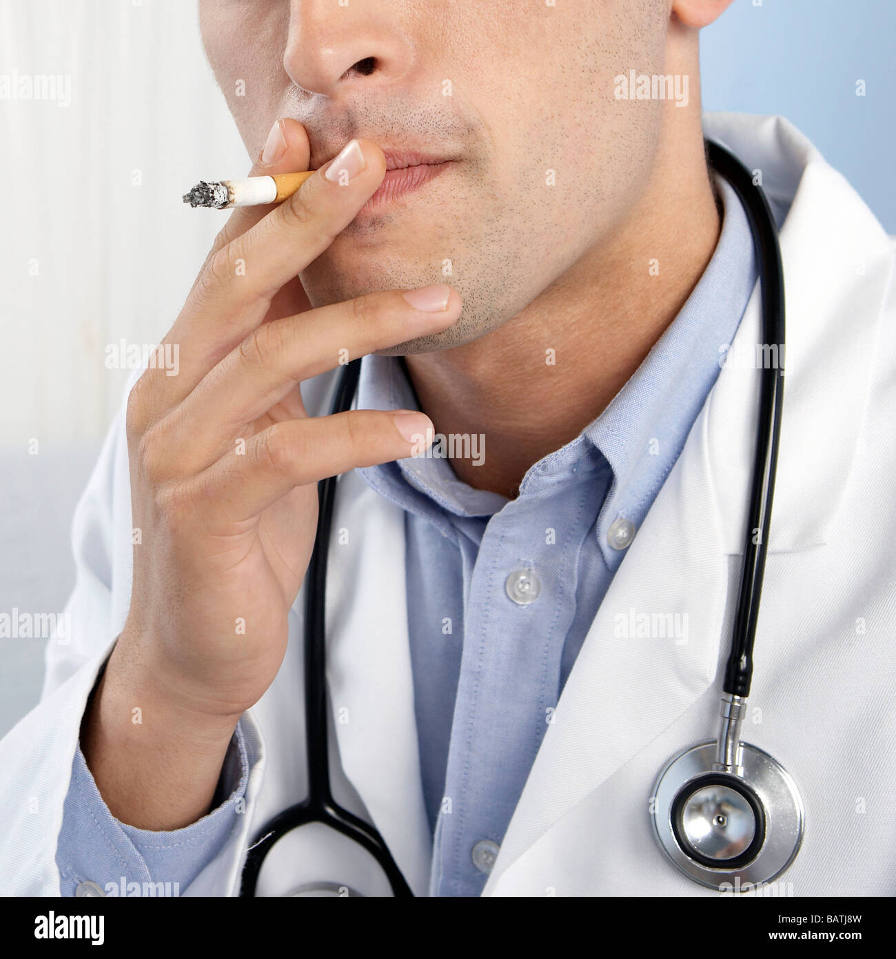 Doctor smoking a cigarette. Cigarettes contain the addictive ...