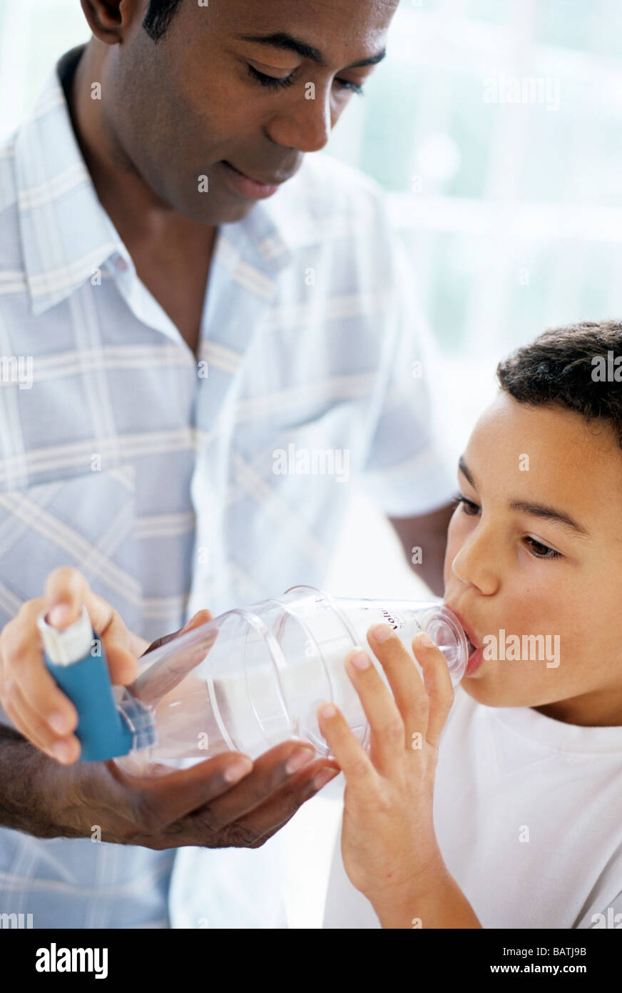 Child using inhaler and spacer hi-res stock photography and images - Alamy