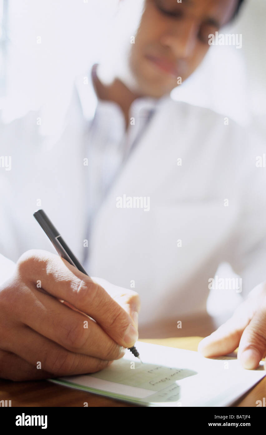 Prescription. General practice doctor writing out a prescription Stock ...