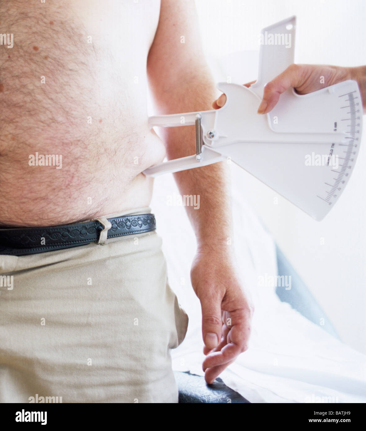 Body fat assessment. 39-year-old overweightman having his body fat ...