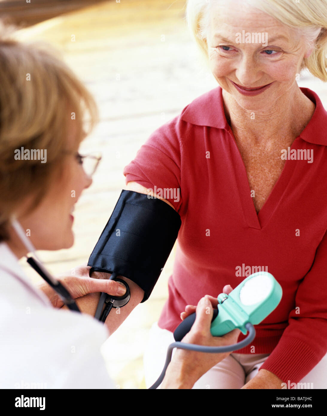 MODEL RELEASED Sphygmomanometer and stethoscope being used by a doctor ...