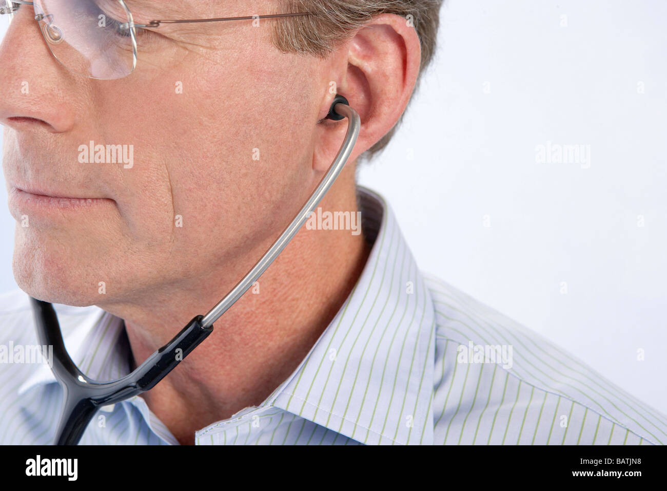 Doctor using a stethoscope. The stethoscope allows the doctor to listen ...