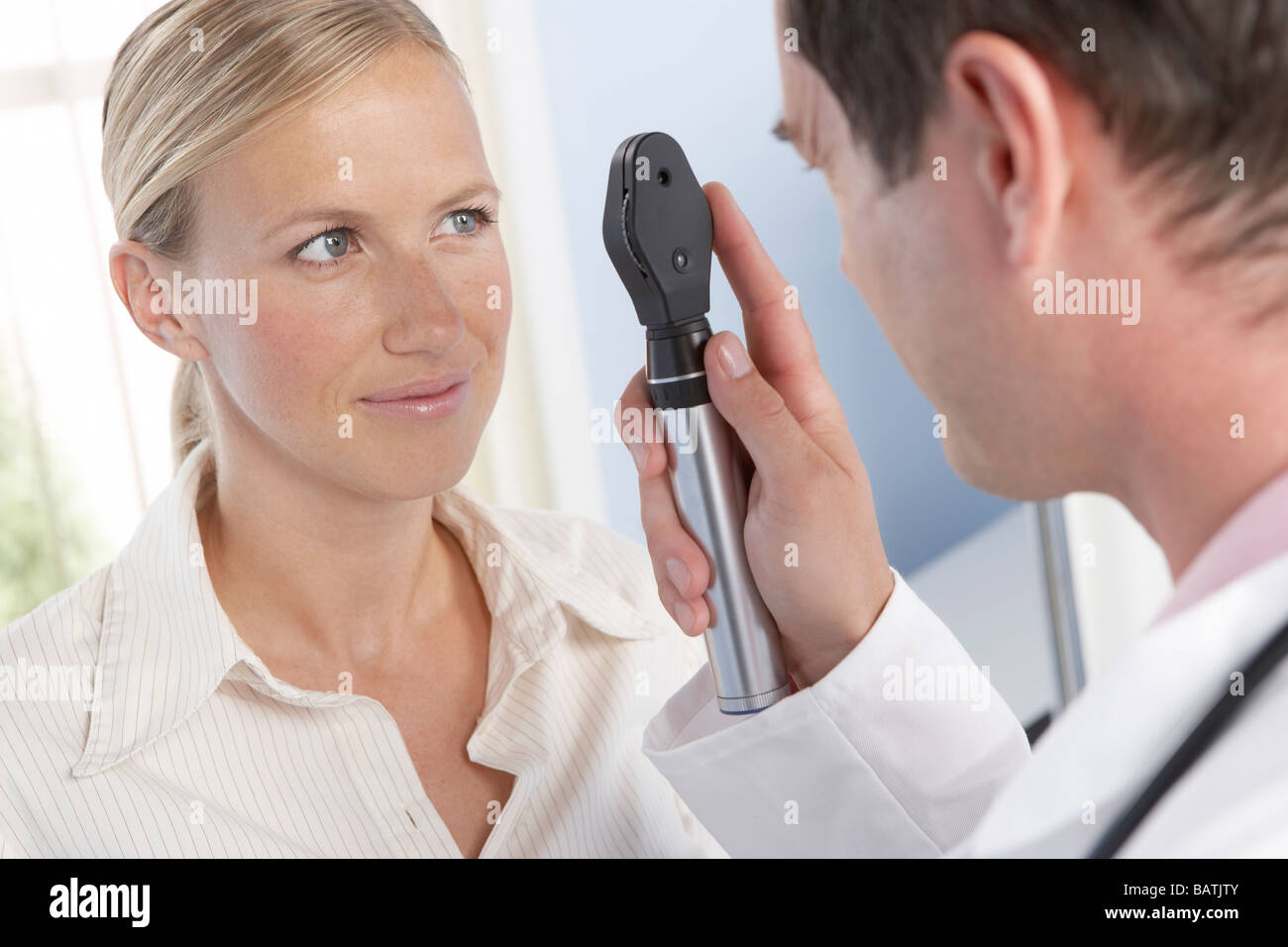 Eye examination. Doctor using an ophthalmoscope during an eye ...
