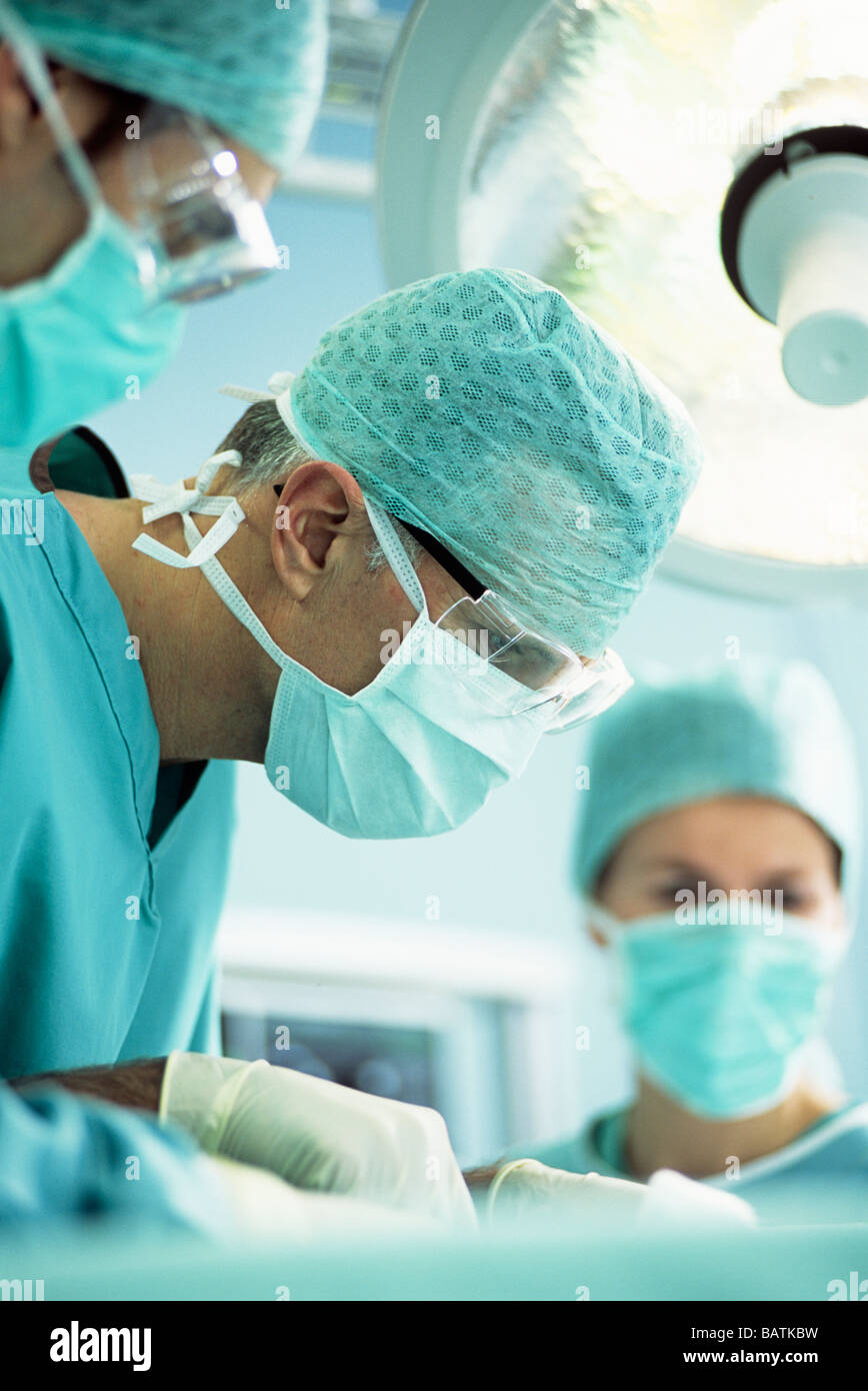 Surgeon performing anoperation Stock Photo - Alamy