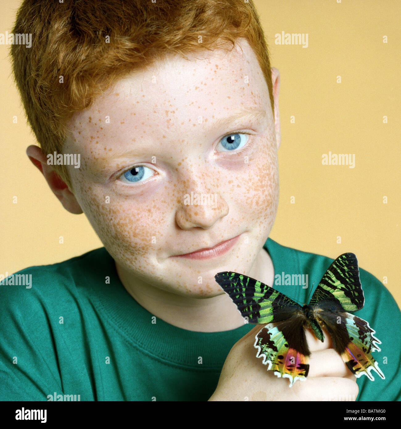 Butterfly being held by a nine year old boy Stock Photo - Alamy