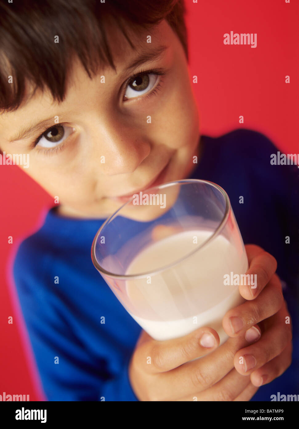 Drinking milk. 7-year-old boyholding a glass of milk. Milk is a good ...