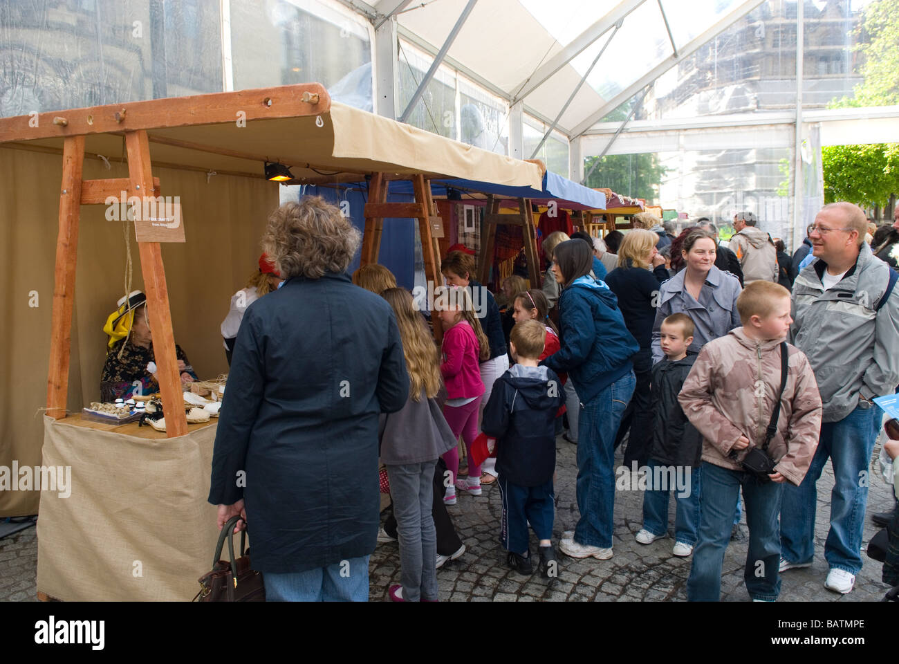 People by the stalls of the Spanish festival market in Manchester UK ...