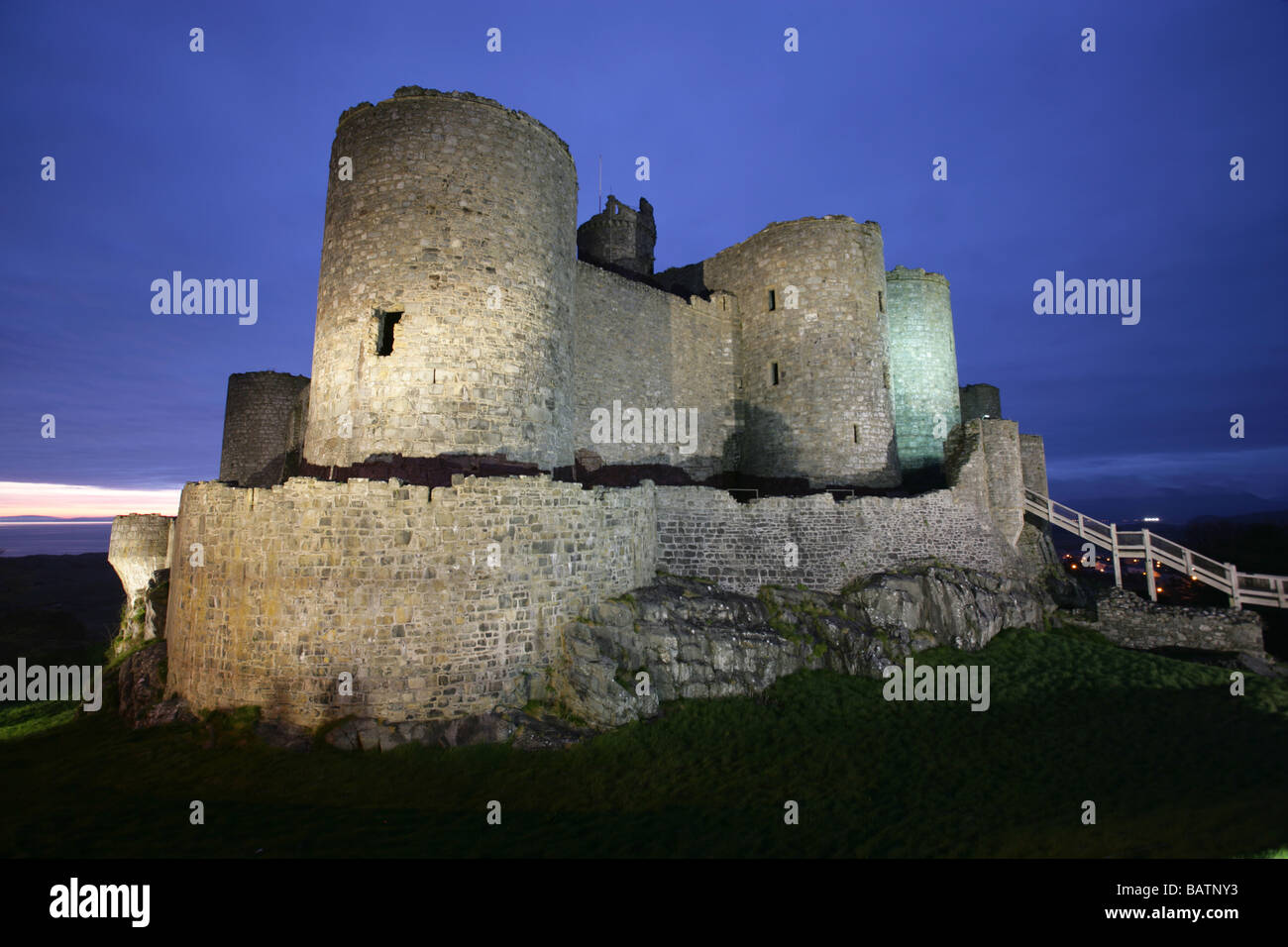 Town of Harlech, Wales. Night floodlit view of the south east elevation ...