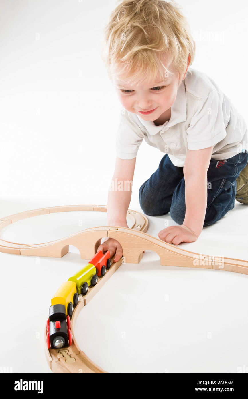 toddler boy playing with toy train set Stock Photo - Alamy
