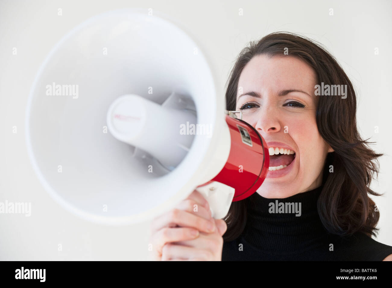 Woman shouting through megaphone, studio shot Stock Photo - Alamy