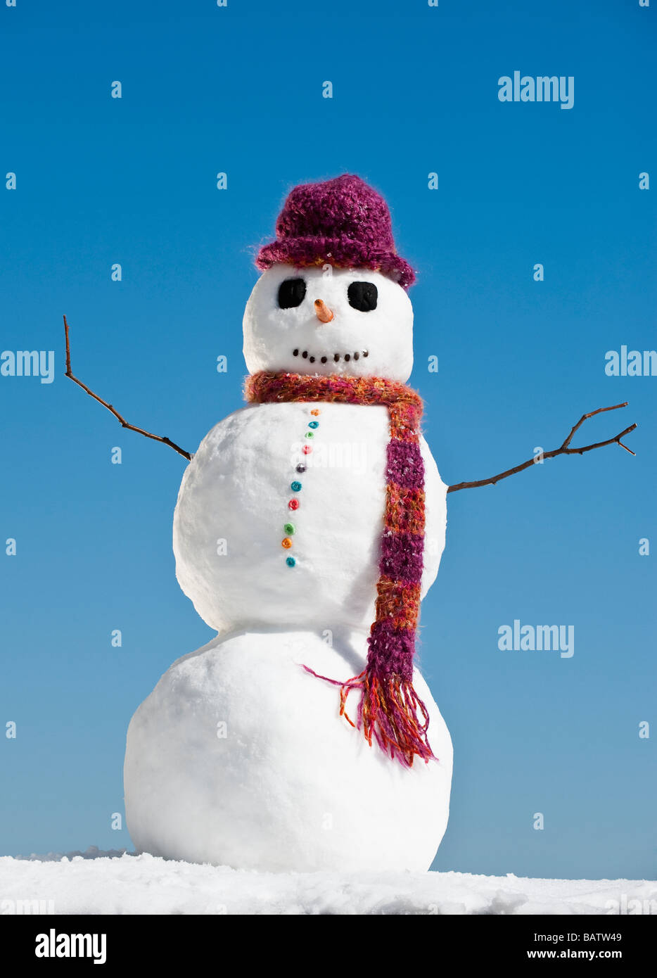 Snowman wearing hat and scarf, clear sky in background Stock Photo - Alamy