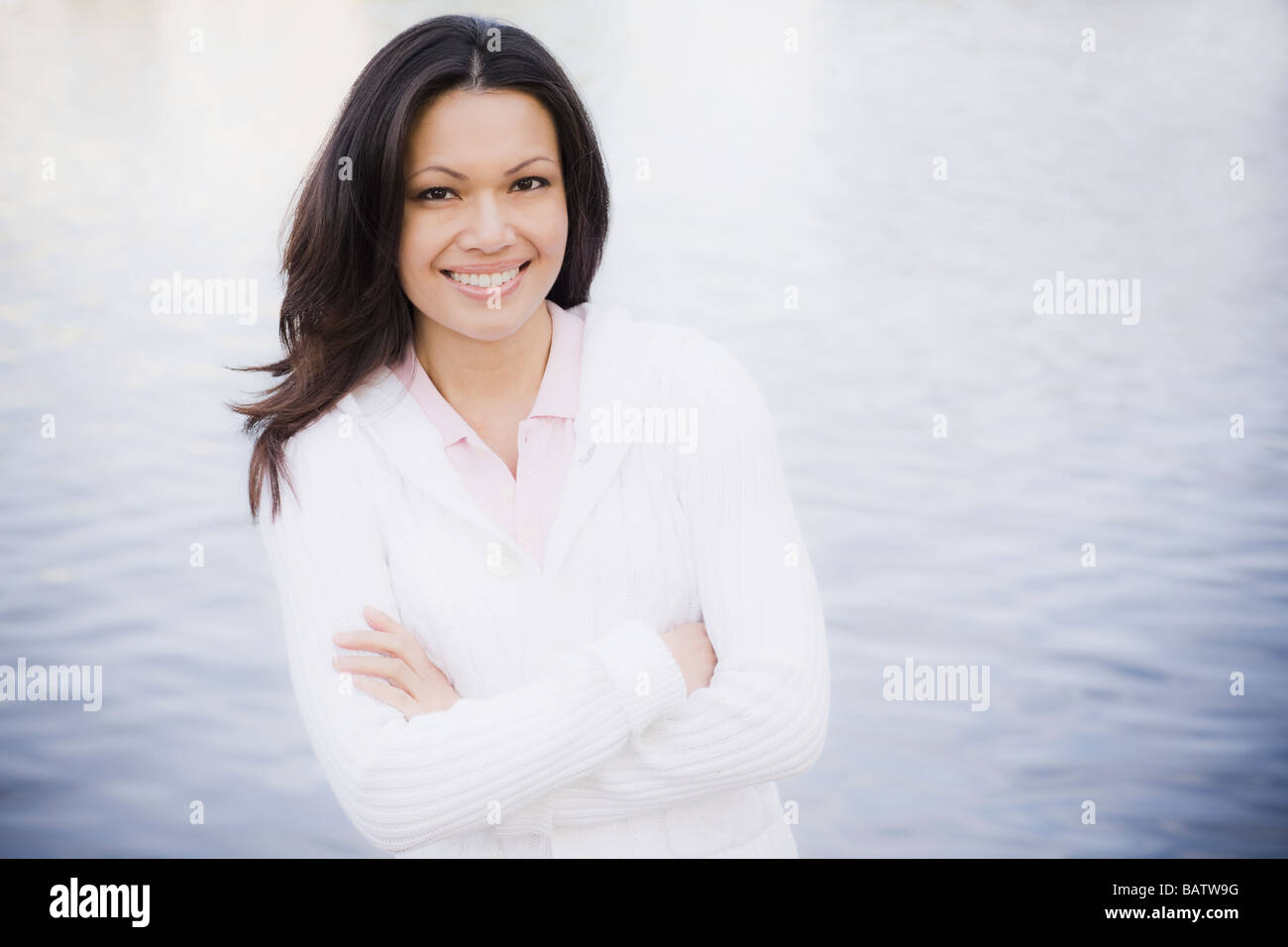 Portrait of woman smiling by sea Stock Photo - Alamy