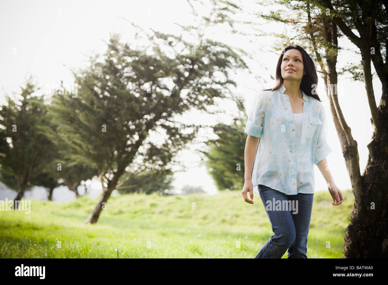 Woman walking in park Stock Photo - Alamy
