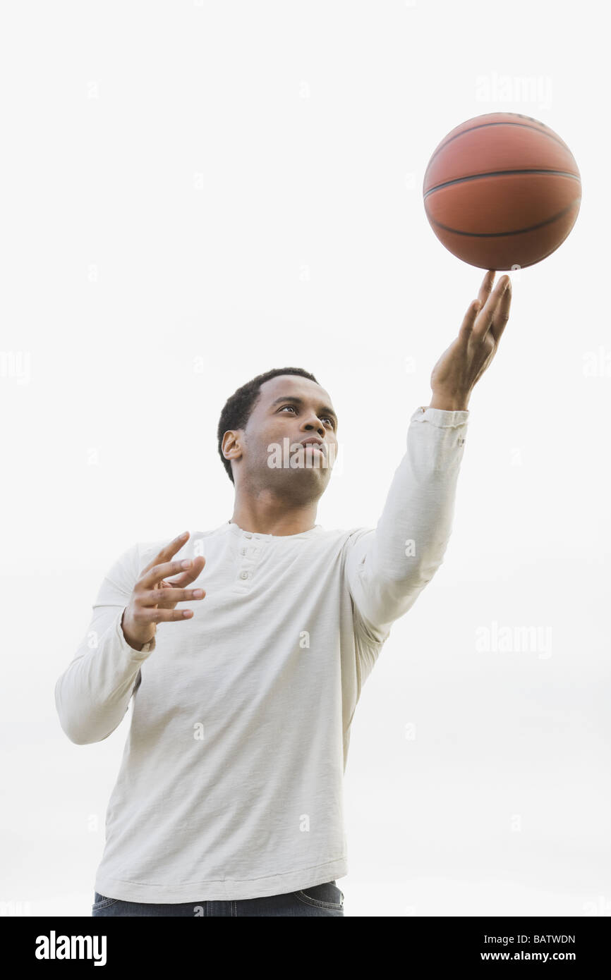 Man playing with basketball, studio shot Stock Photo - Alamy