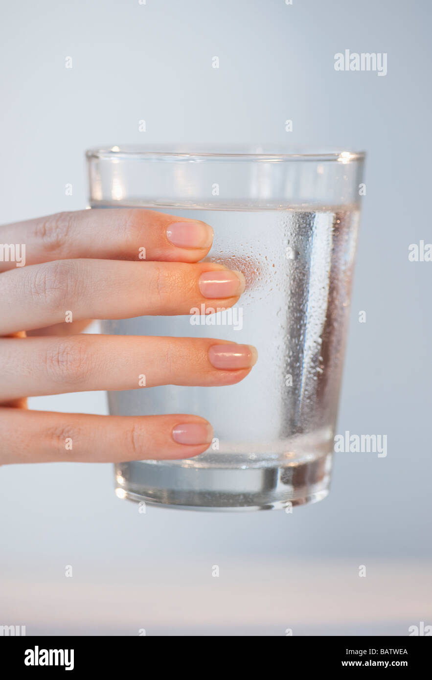 Close up hand holding water glass hi-res stock photography and images ...