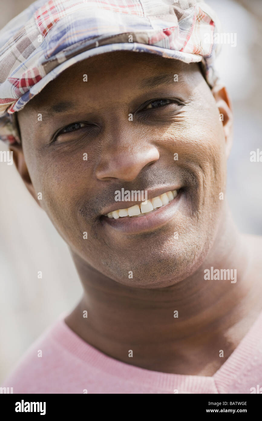 Portrait of man wearing cap, smiling Stock Photo - Alamy