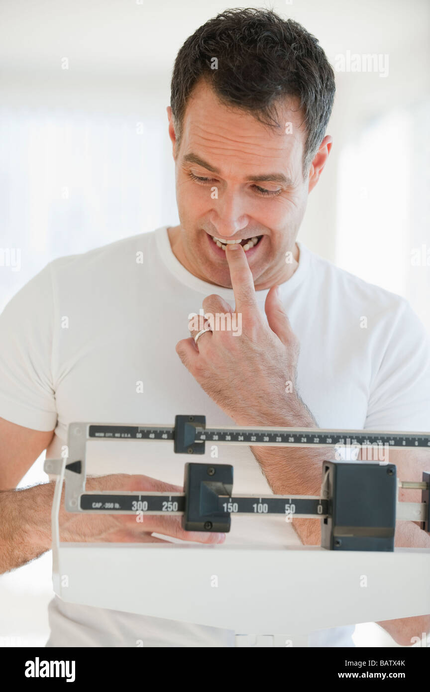 Mature man on scales Stock Photo - Alamy