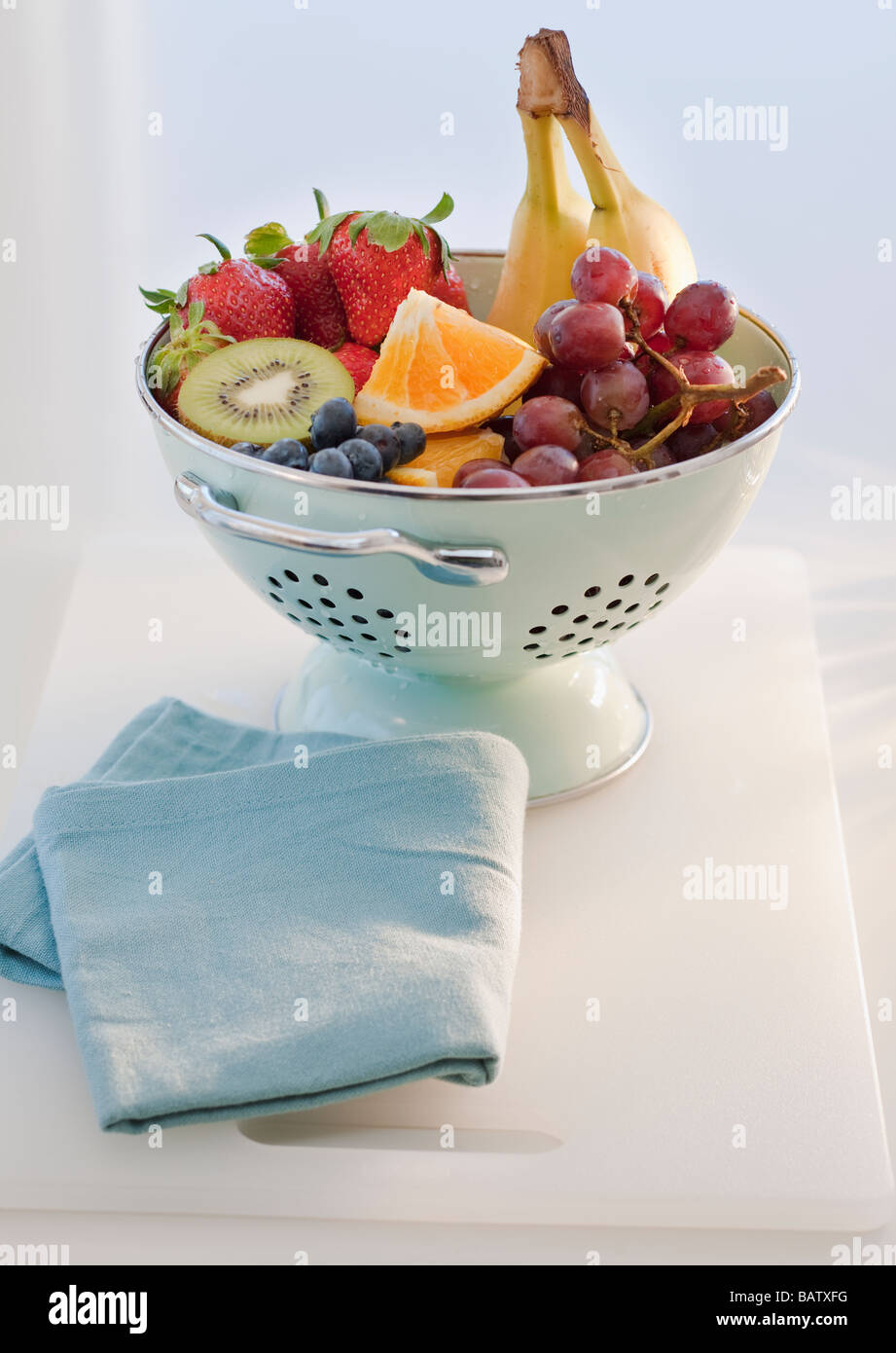 Colander with fruits Stock Photo - Alamy