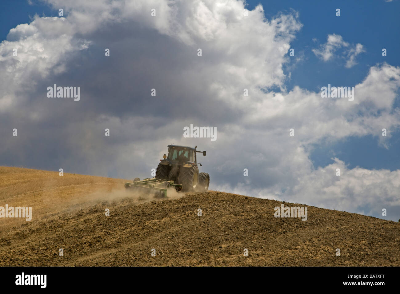 Italy, Tuscany, Tractor driving across field Stock Photo - Alamy